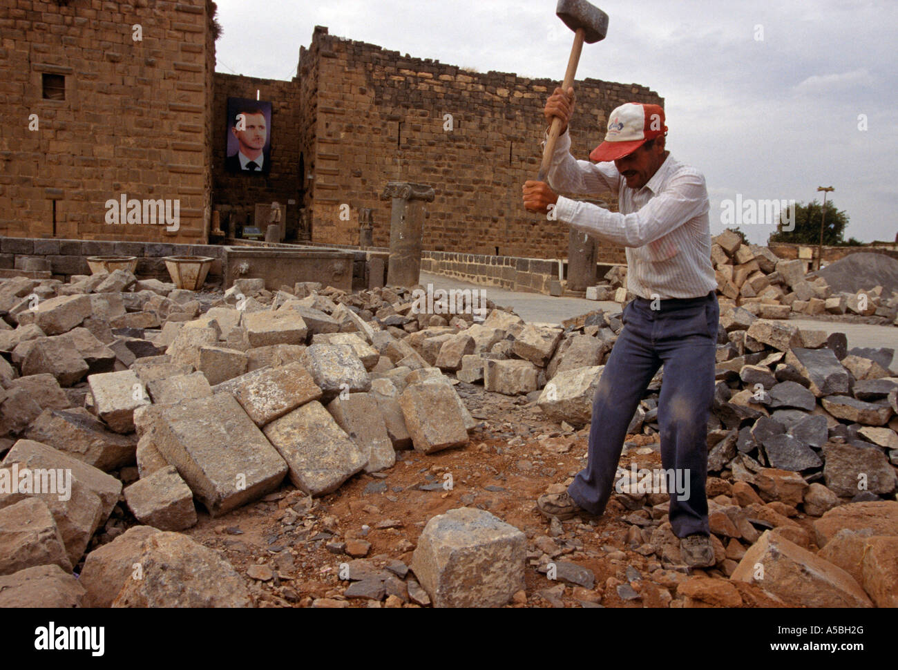 A man hammering rocks from the ruins of Byzantine houses in Aleppo ...