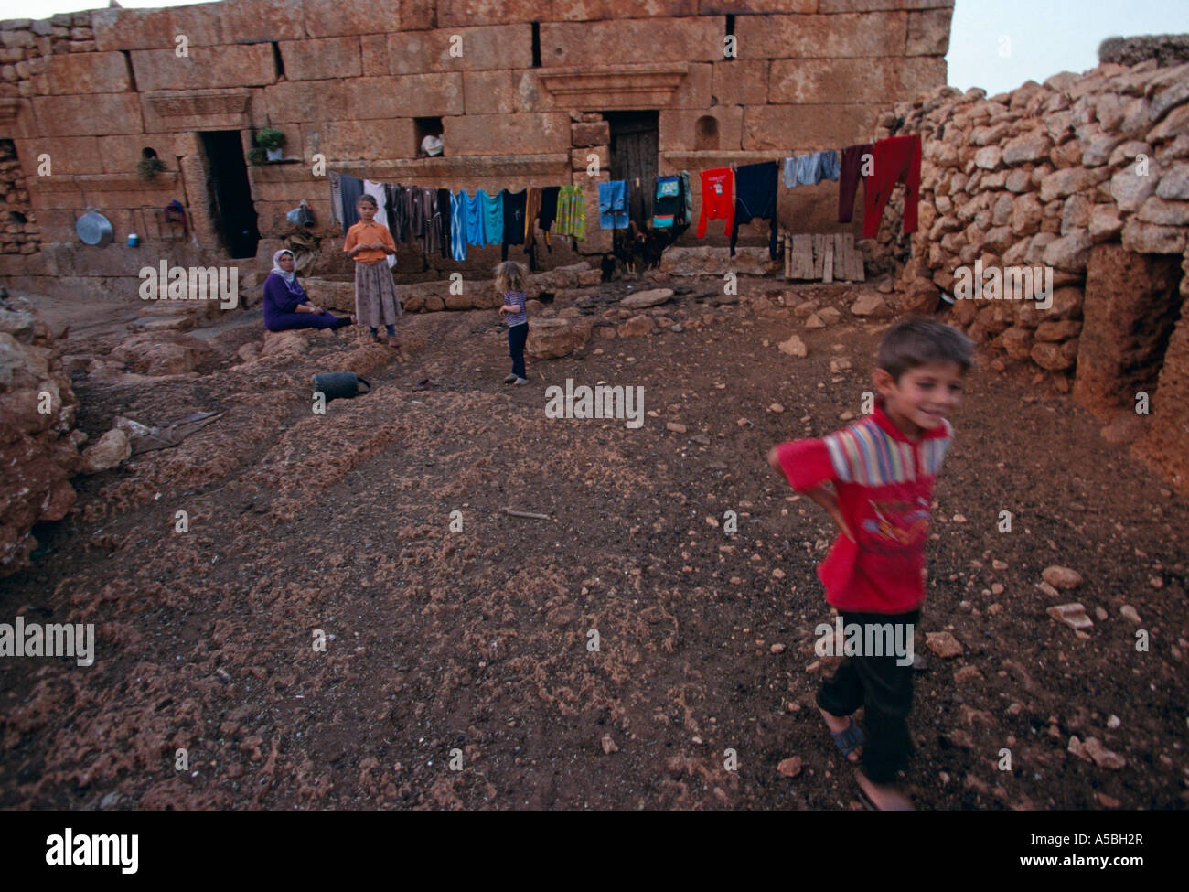 Family of four outside home, Byzantine village, Aleppo, Syria Stock ...