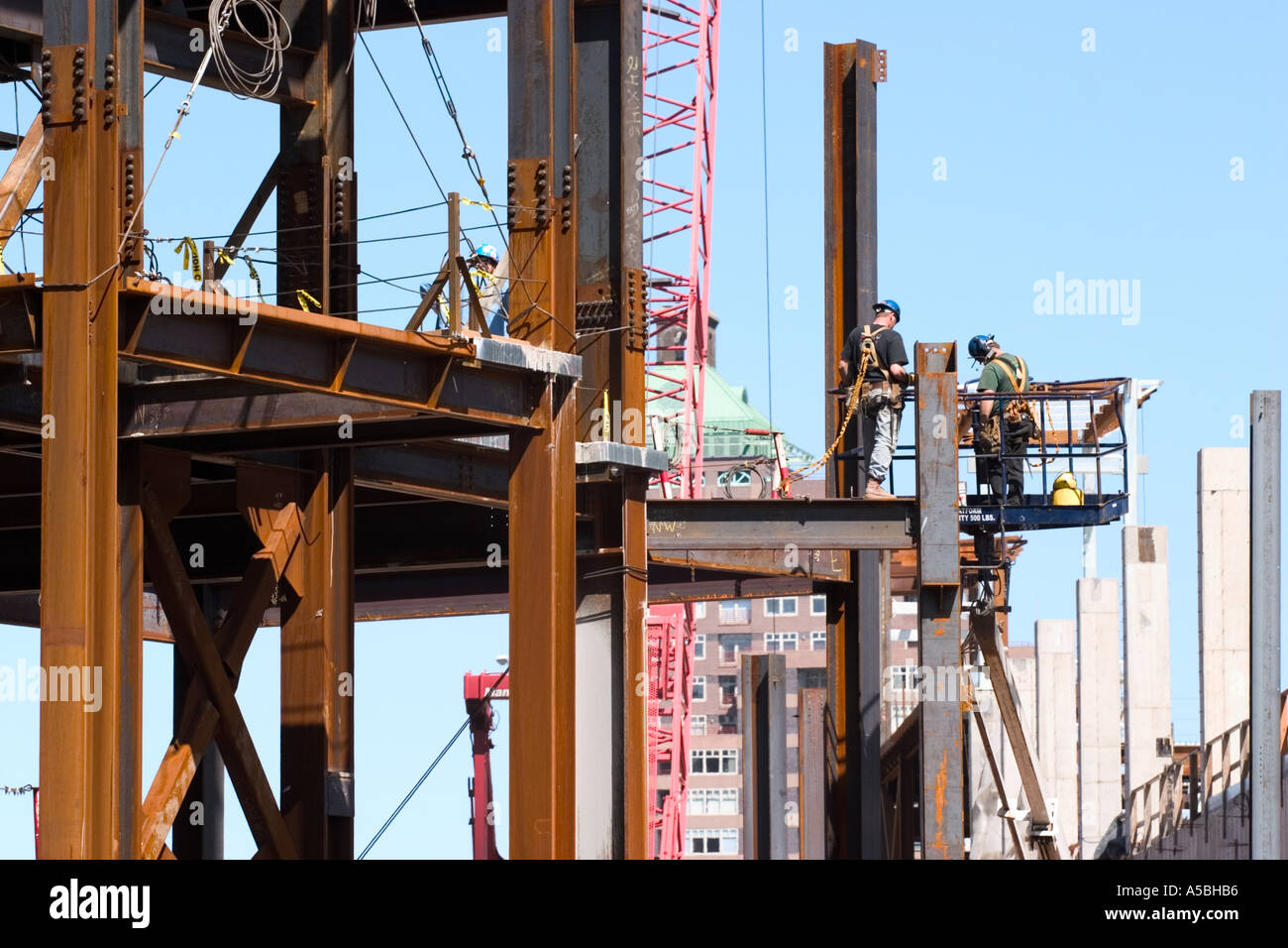 Construction workers helping to erect a building Stock Photo - Alamy