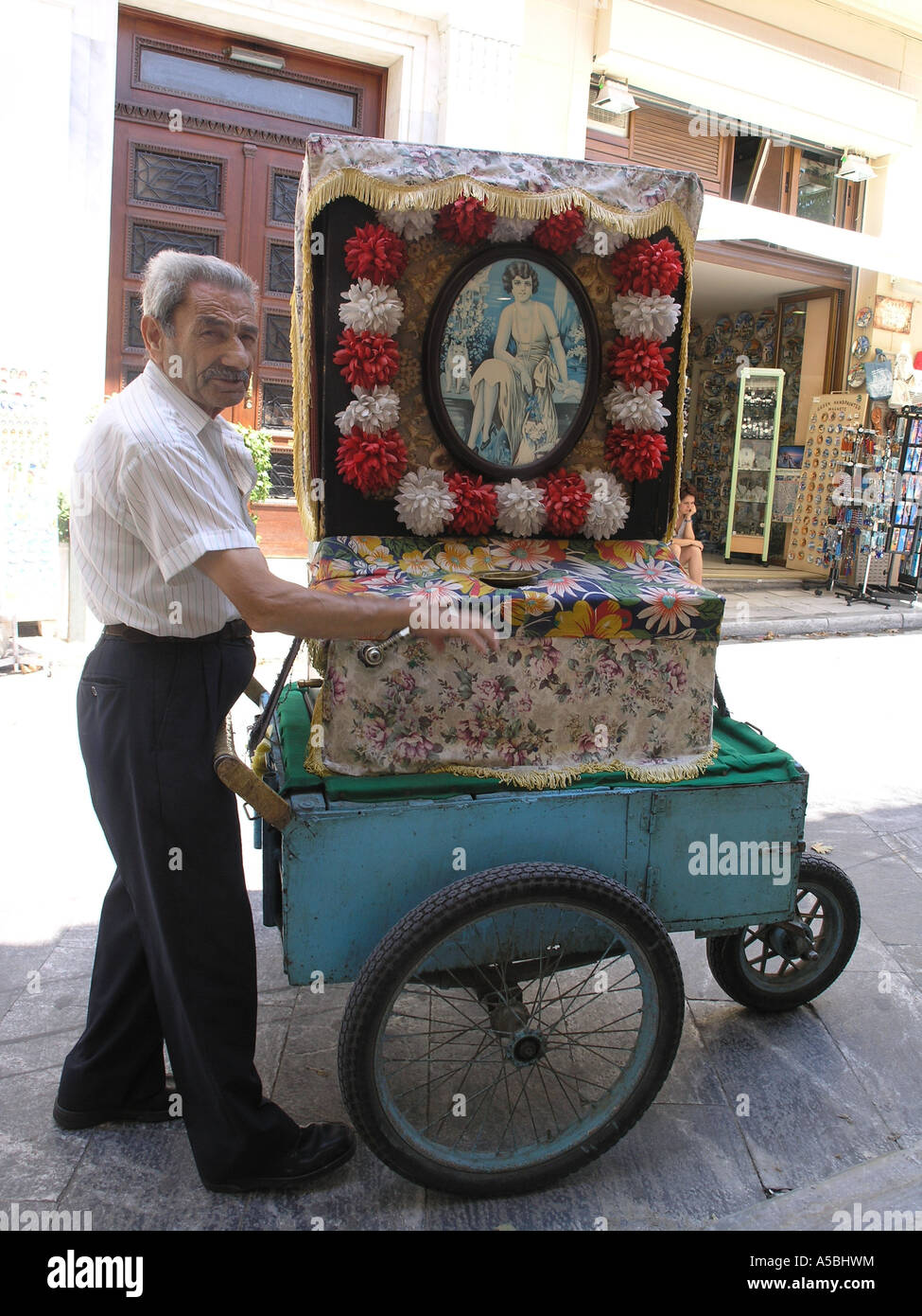 Old man playing mechanical street organ in old town Plaka of Athens ...
