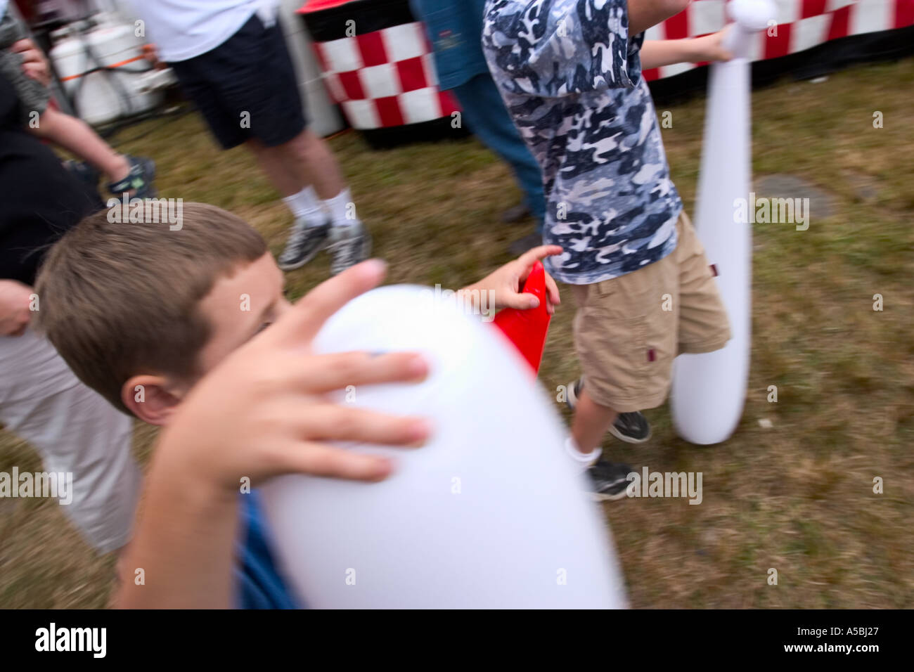 Young boy at a fair carrying an object Stock Photo - Alamy