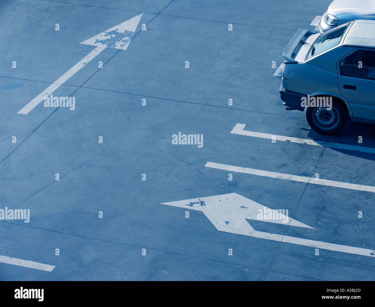 Traffic directional arrows in parking lot Stock Photo - Alamy