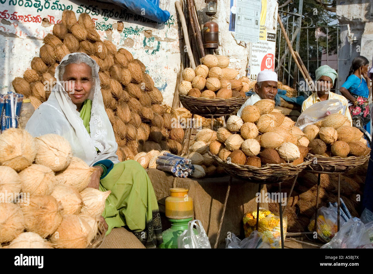 Indian street traders selling coconuts outside a temple gate. Andhra ...