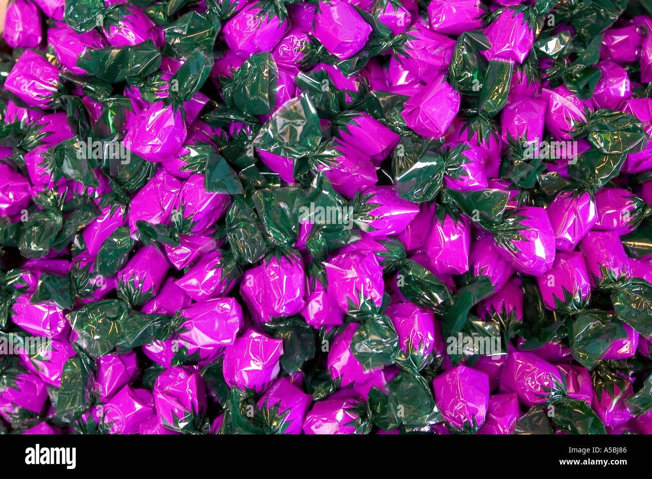 Piles of pink wrapped candies Stock Photo - Alamy