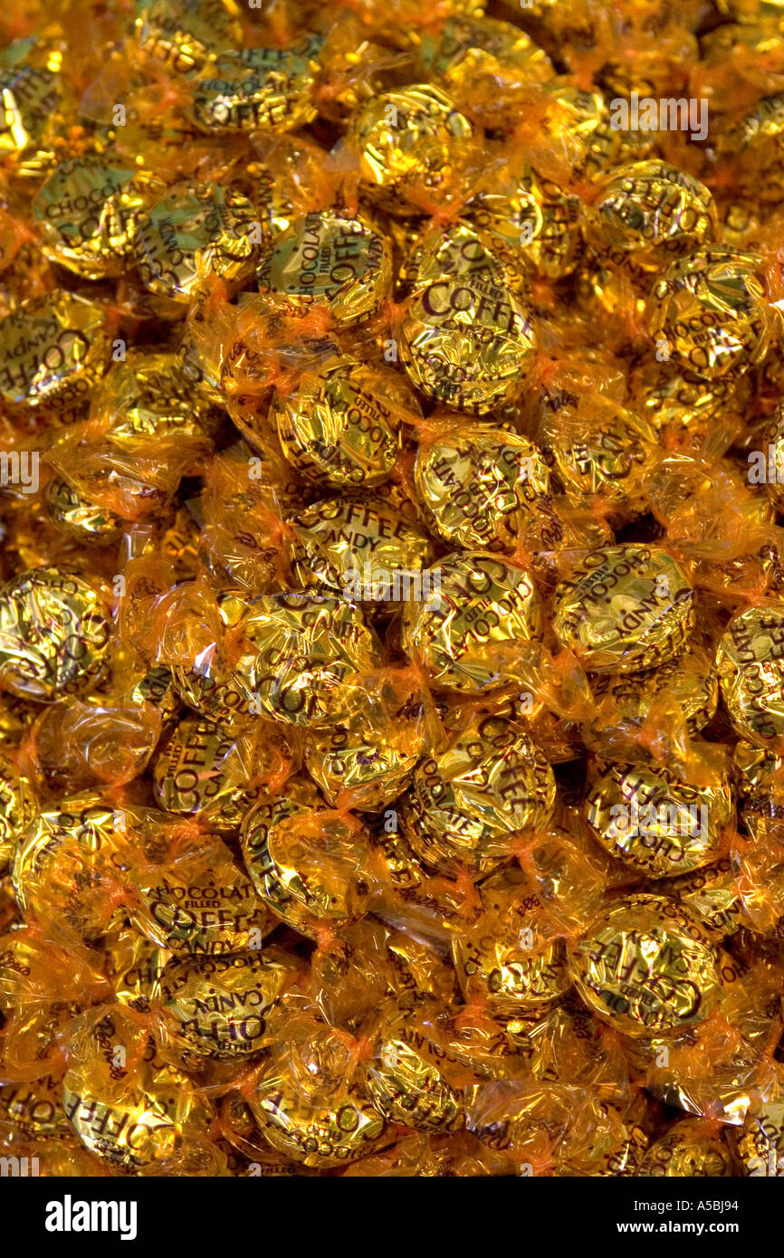 Piles of gold wrapped candies Stock Photo - Alamy