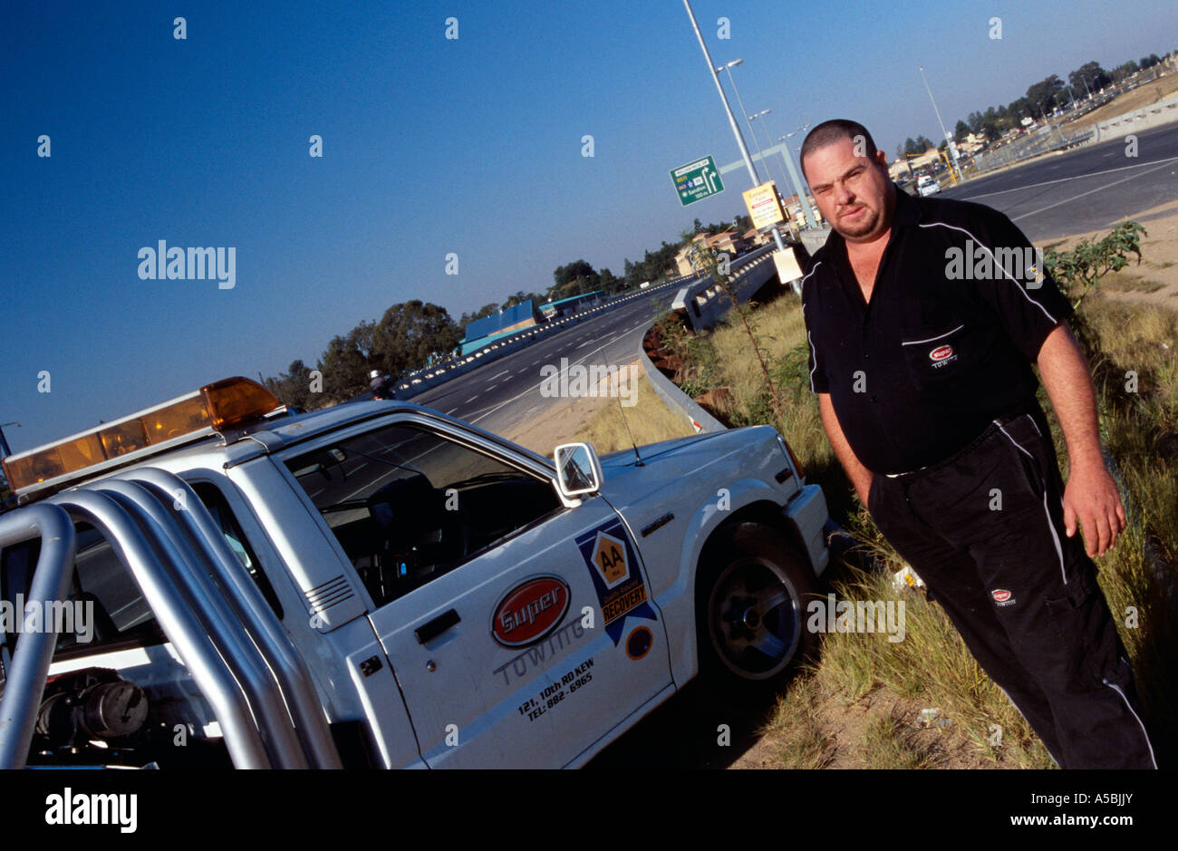 A man standing beside a tow truck in Johannesburg South Africa Stock ...
