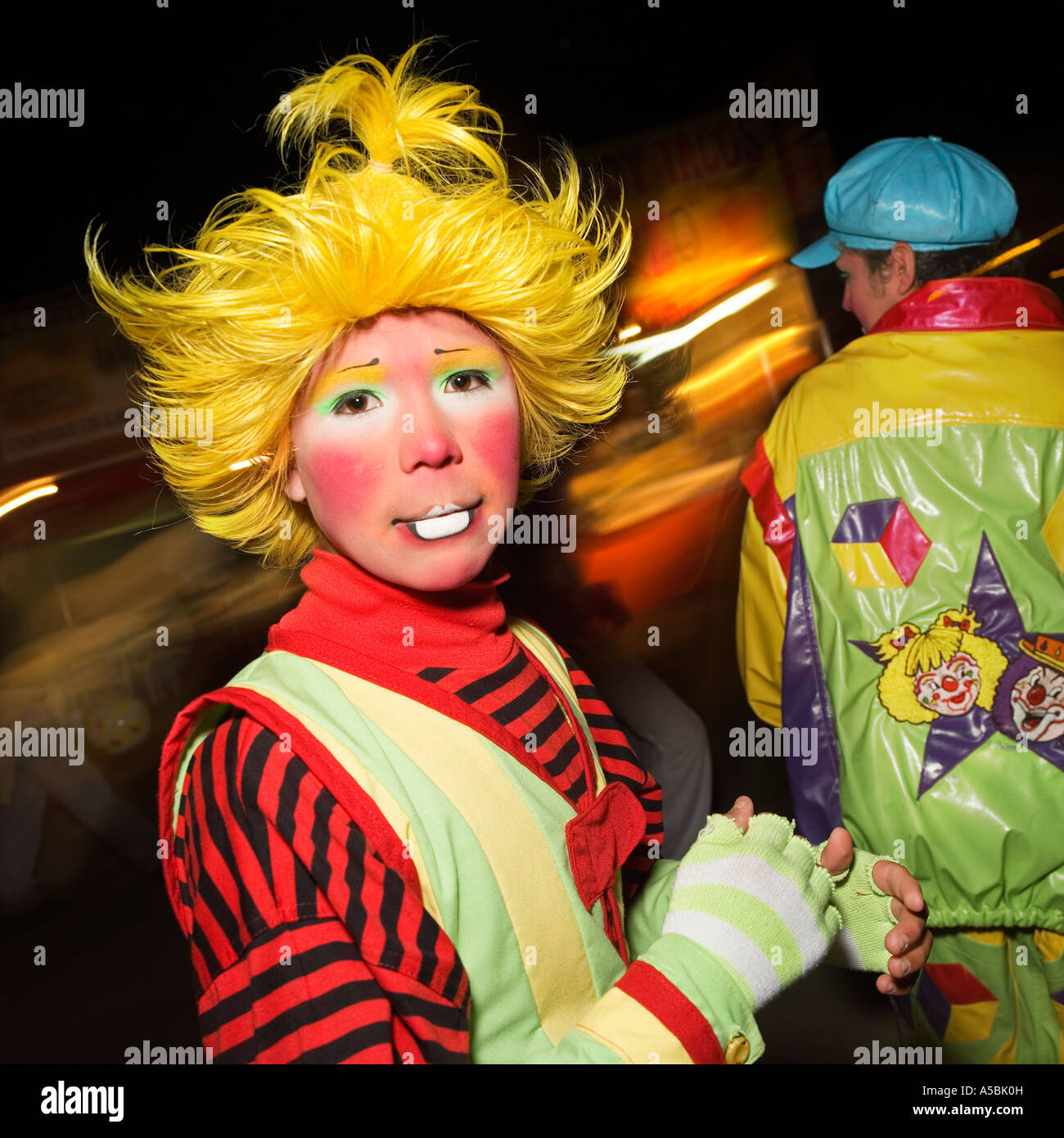 carnival clown vibrant night time Stock Photo - Alamy
