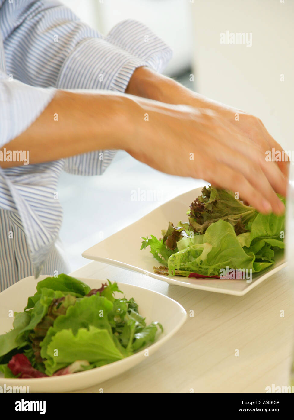 Mid section view of a man preparing salad Stock Photo - Alamy