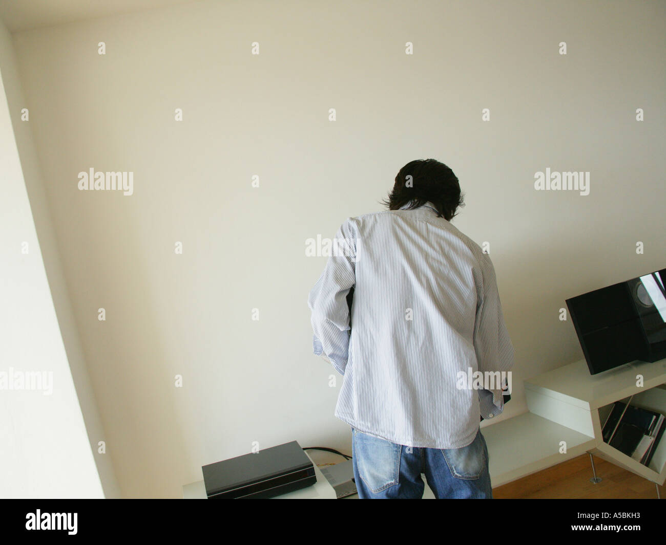 Rear view of a man bending Stock Photo - Alamy