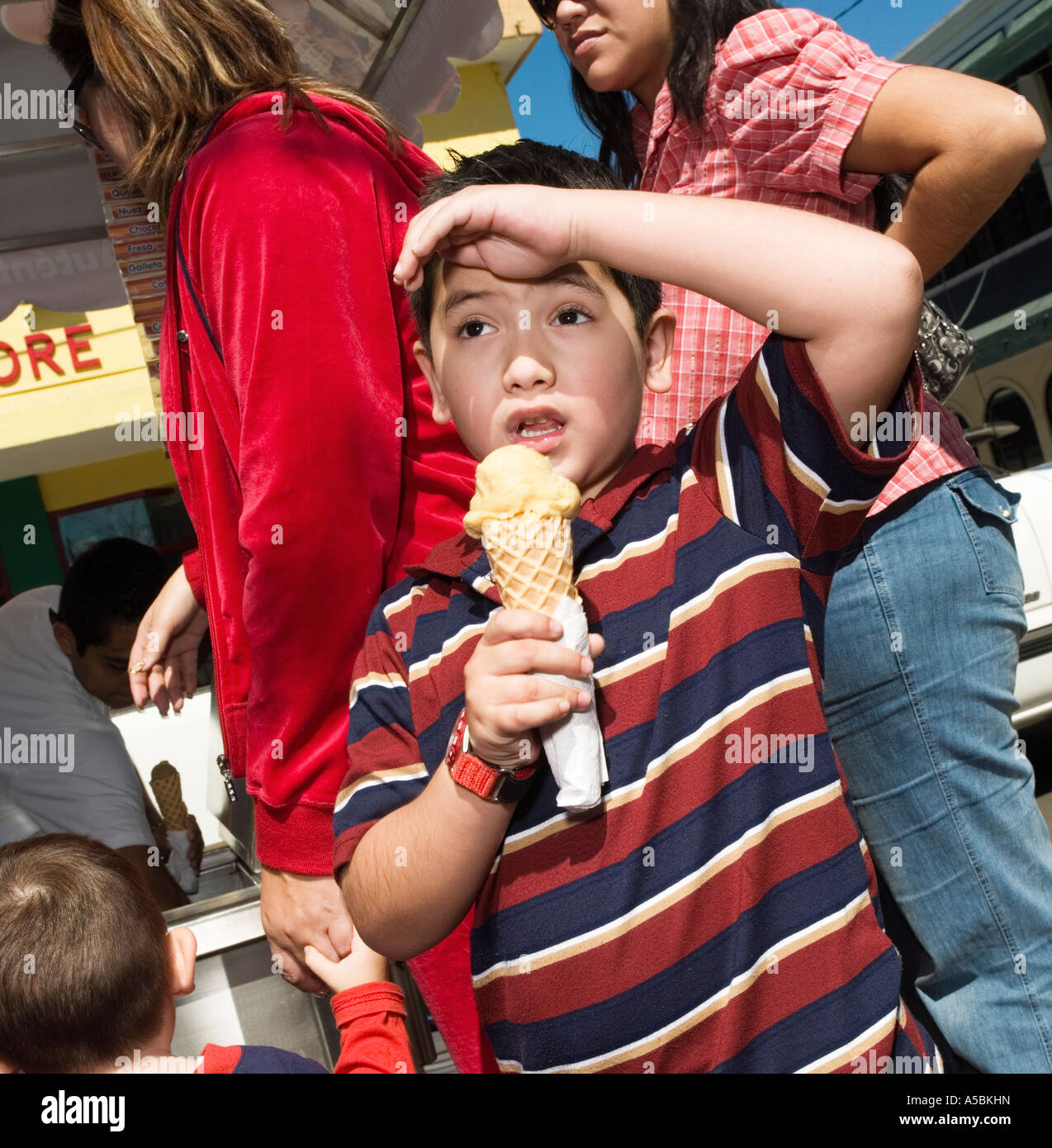 Ice Cream boy shading cone from sun Stock Photo - Alamy