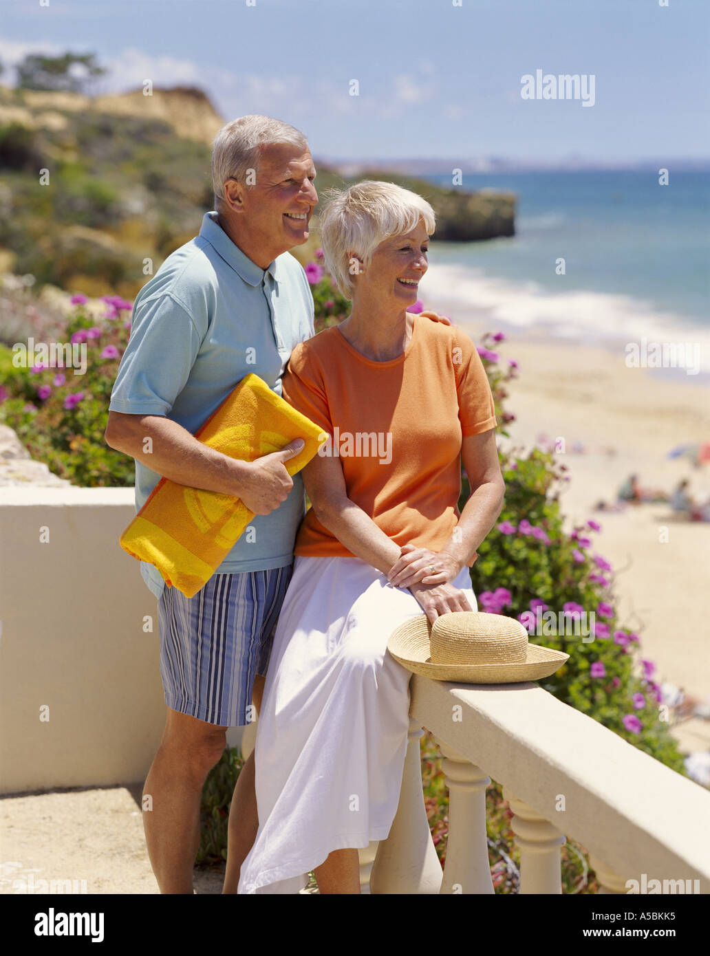 couple of retirement age on holiday above beach near Albufeira, Algarve ...