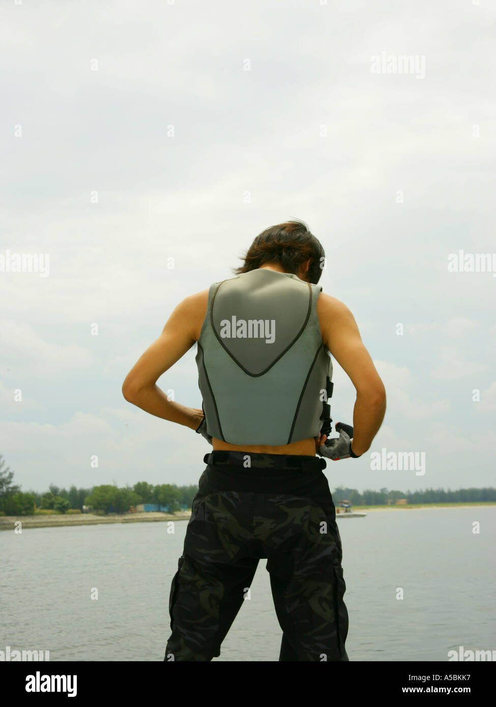 Rear view of a young man standing Stock Photo - Alamy
