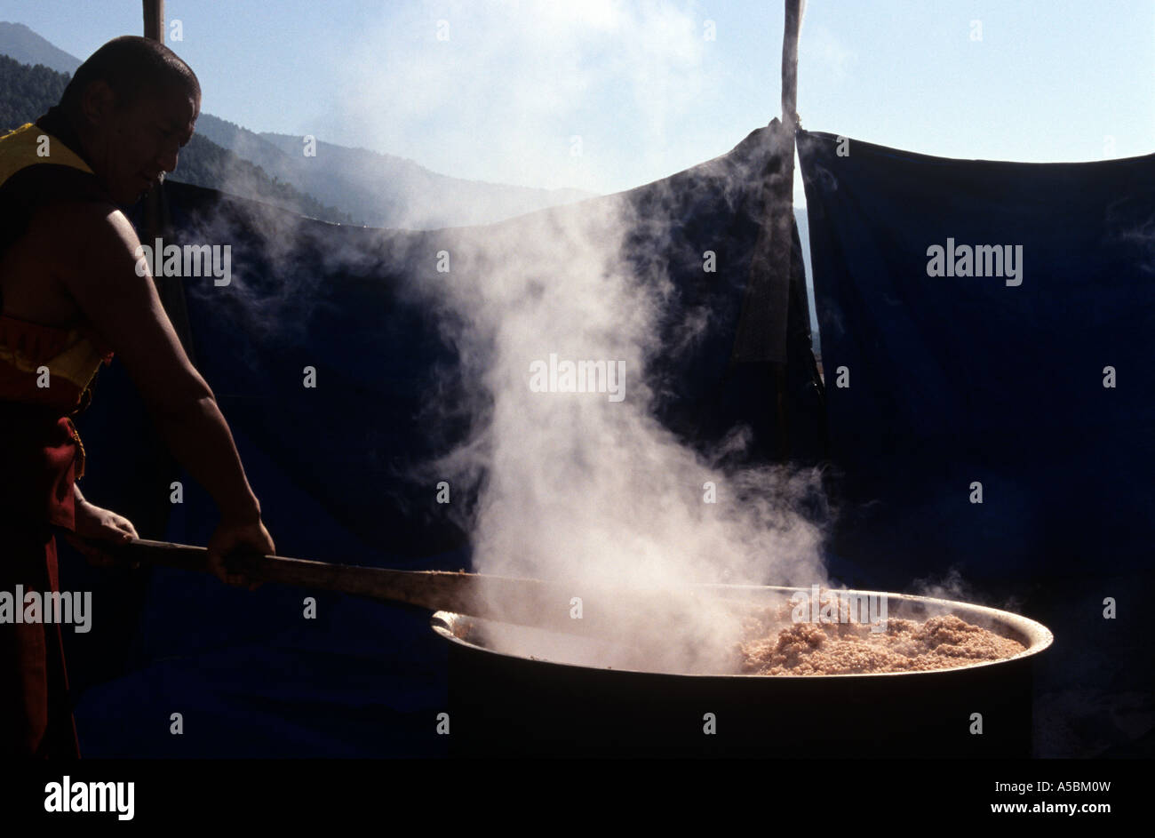 A Buddhist monk cooking in Bhutan Stock Photo - Alamy