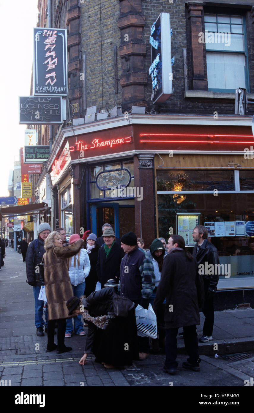 A group of people standing outside the Shampan Restaurant in London ...