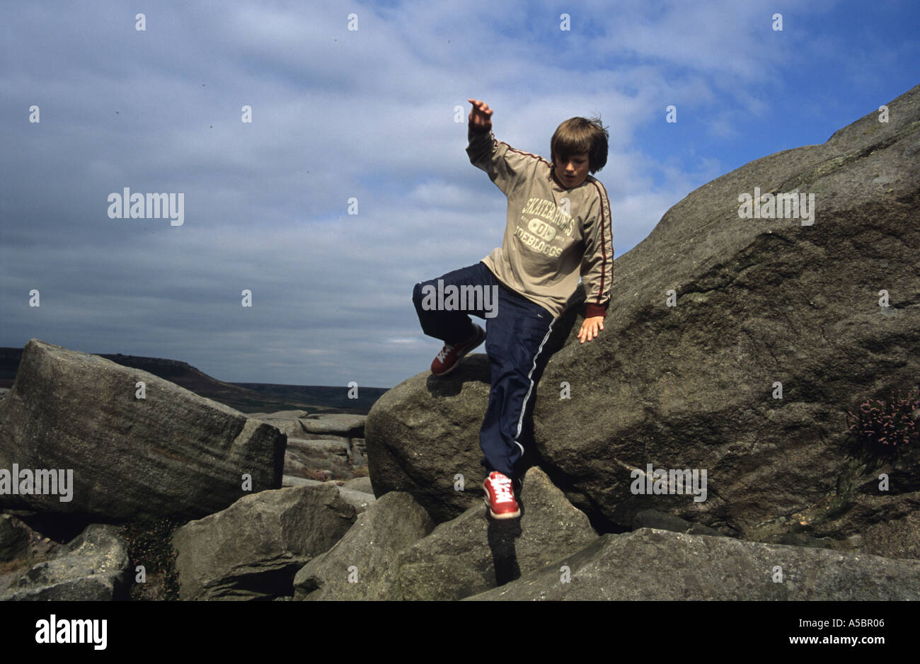 Boy jumping off rocks Peak District England Stock Photo - Alamy