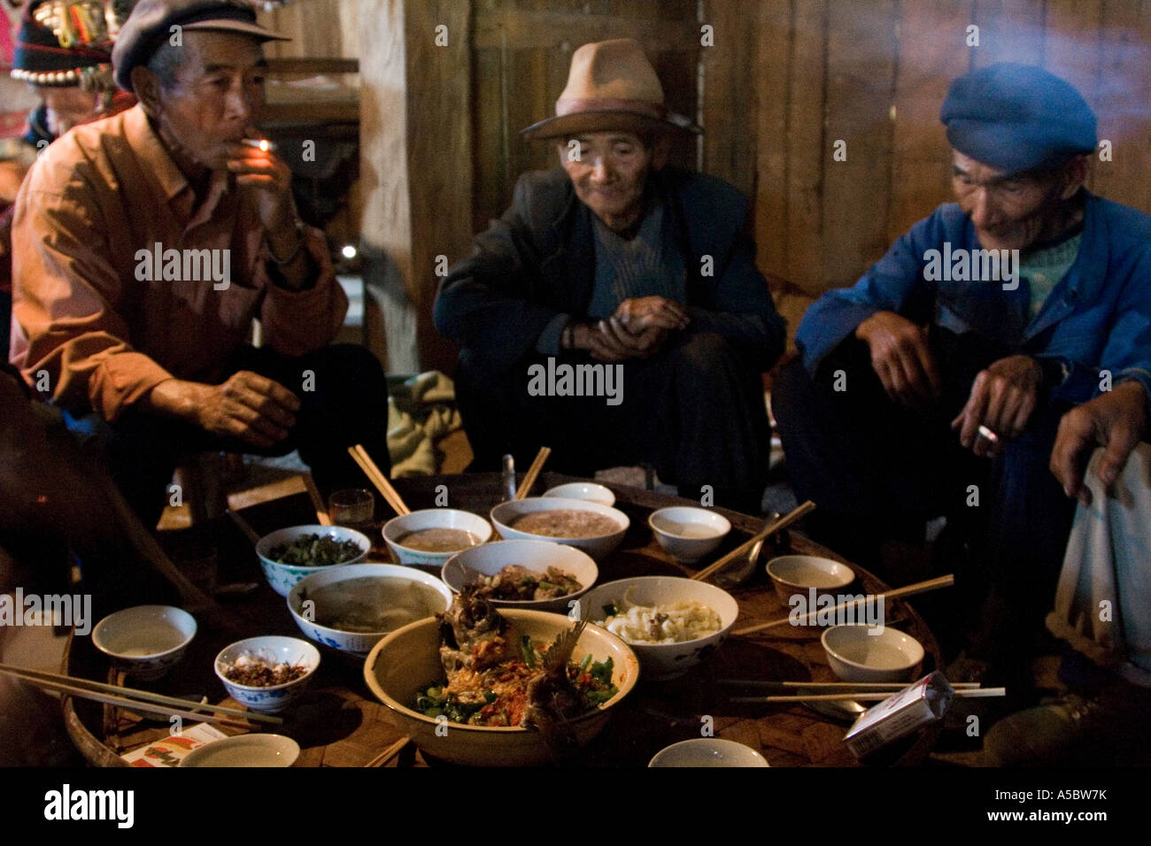 Old Akha Hani Men Smoking and Eating Gelanghe China Stock Photo - Alamy