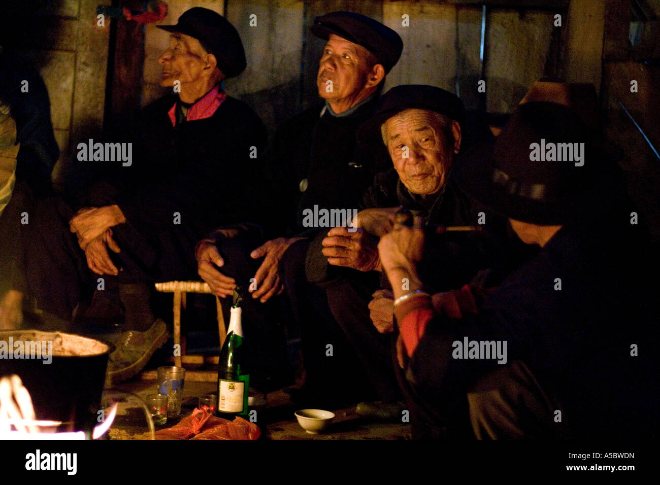 Old Akha Hani Men Sitting around a Fire Indoors Gelanghe China Stock ...