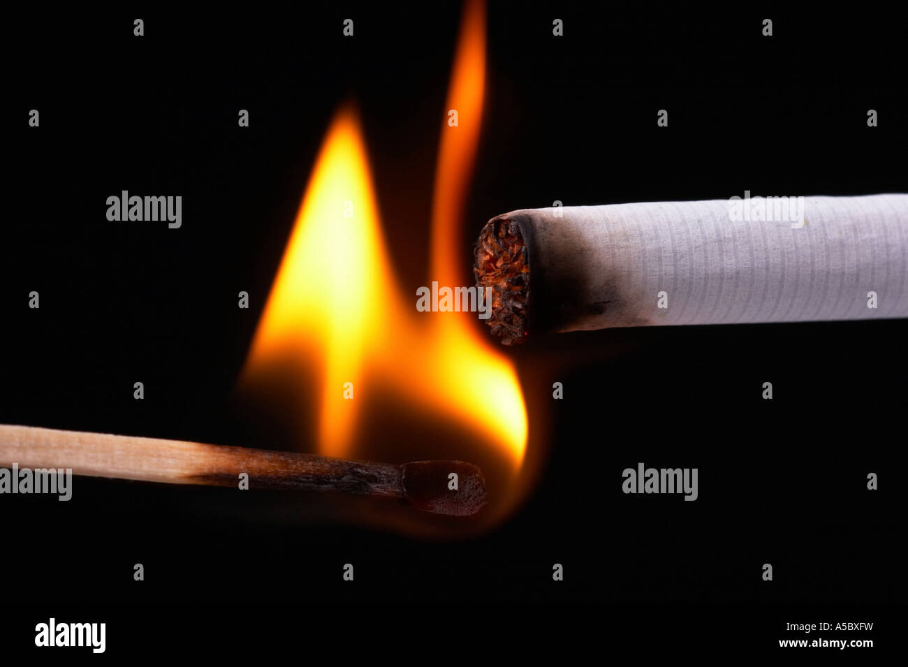 Light a cigarette with a match, black background Stock Photo - Alamy