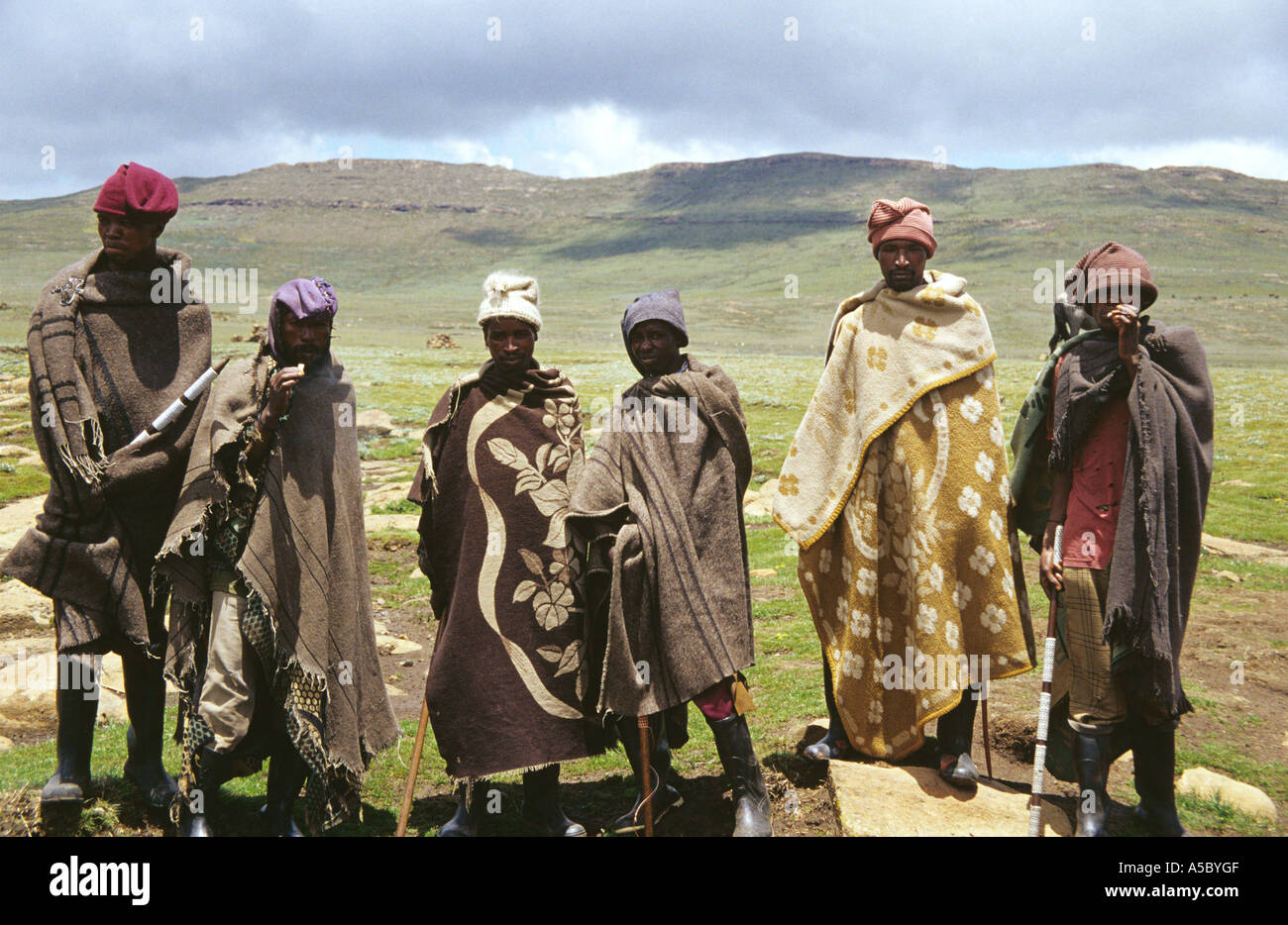 People standing wrapped up in blankets Stock Photo - Alamy