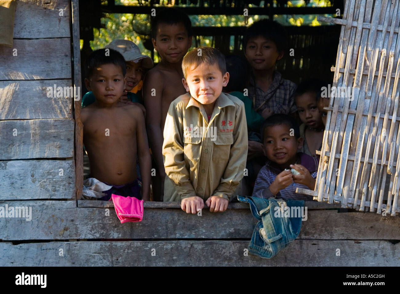 Laotian Children in a Window near Hongsa Laos Stock Photo - Alamy