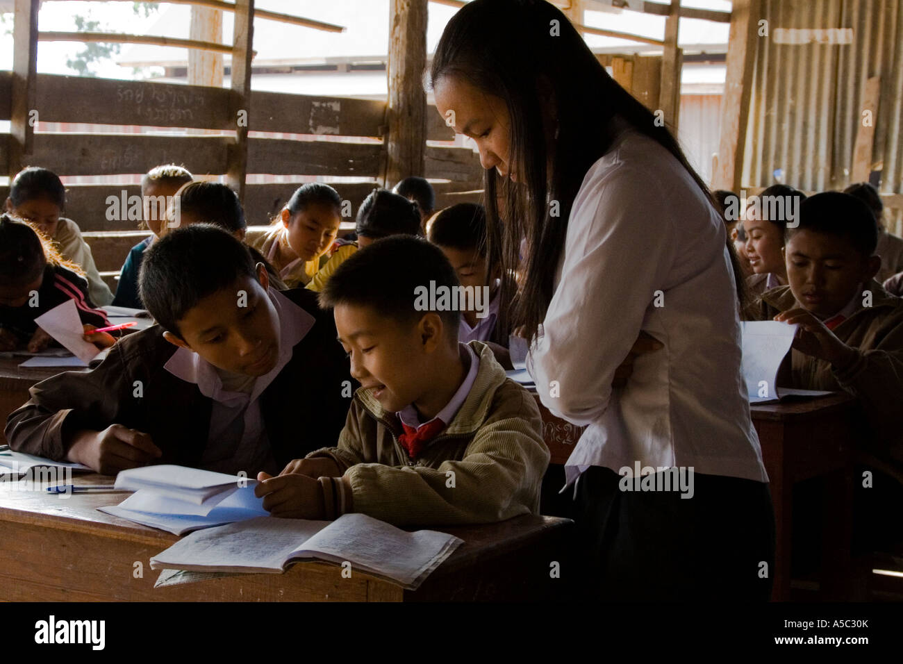 Young Teacher Helping Boys in Class Hongsa Laos Stock Photo - Alamy