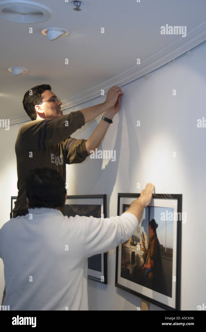 Hanging photographs in a photo Exhibition A matter of Faith by Danny ...
