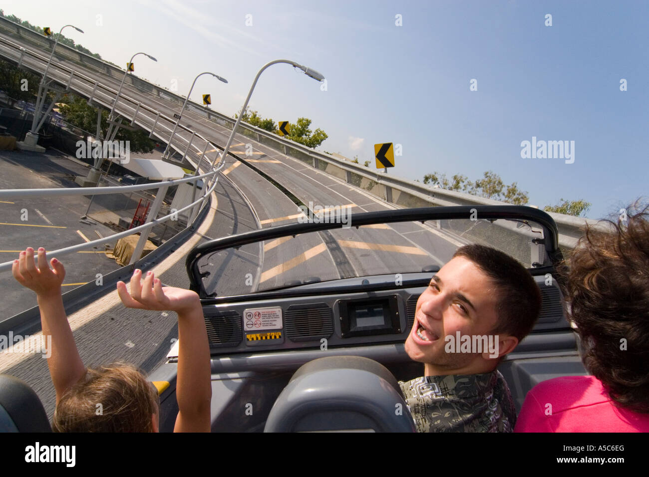 Family on automotive thrill ride in amusement park Stock Photo - Alamy