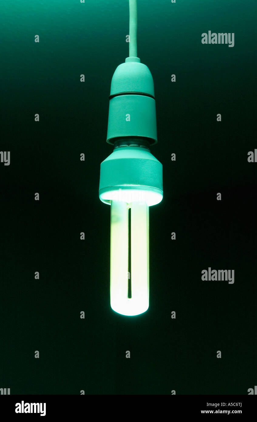 Energy saving electric bulb hanging from ceiling Stock Photo - Alamy