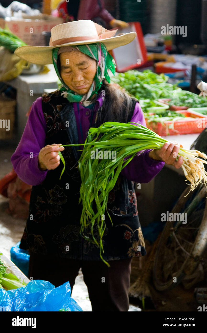 Ethnic Minority Woman Inspecting Green Onions at Market Menghai China ...