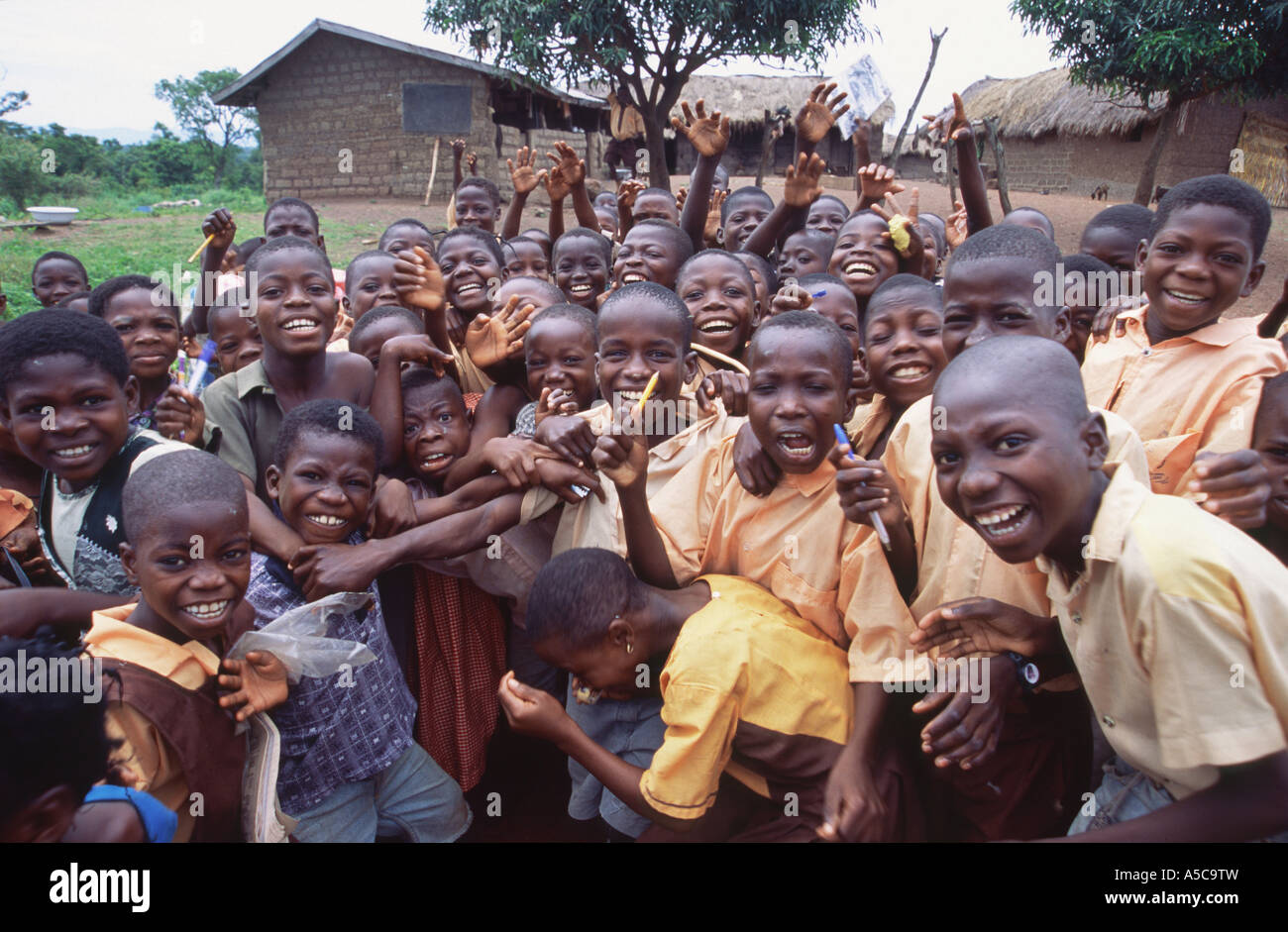 Schoolchildren in Ghana, West Africa laugh and joke in front of the ...