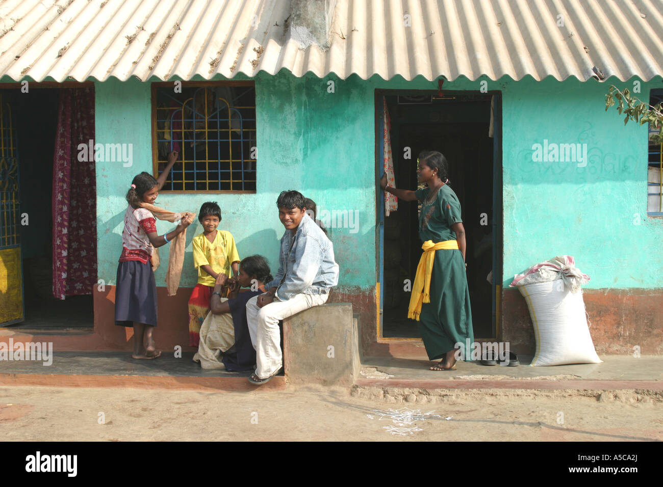 Desia Kondh tribal family outside their village home in Orissa India ...