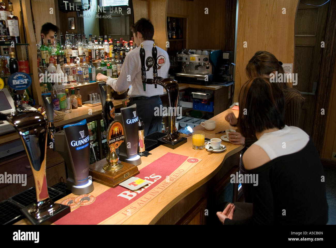 View of people sitting in a bar Stock Photo - Alamy