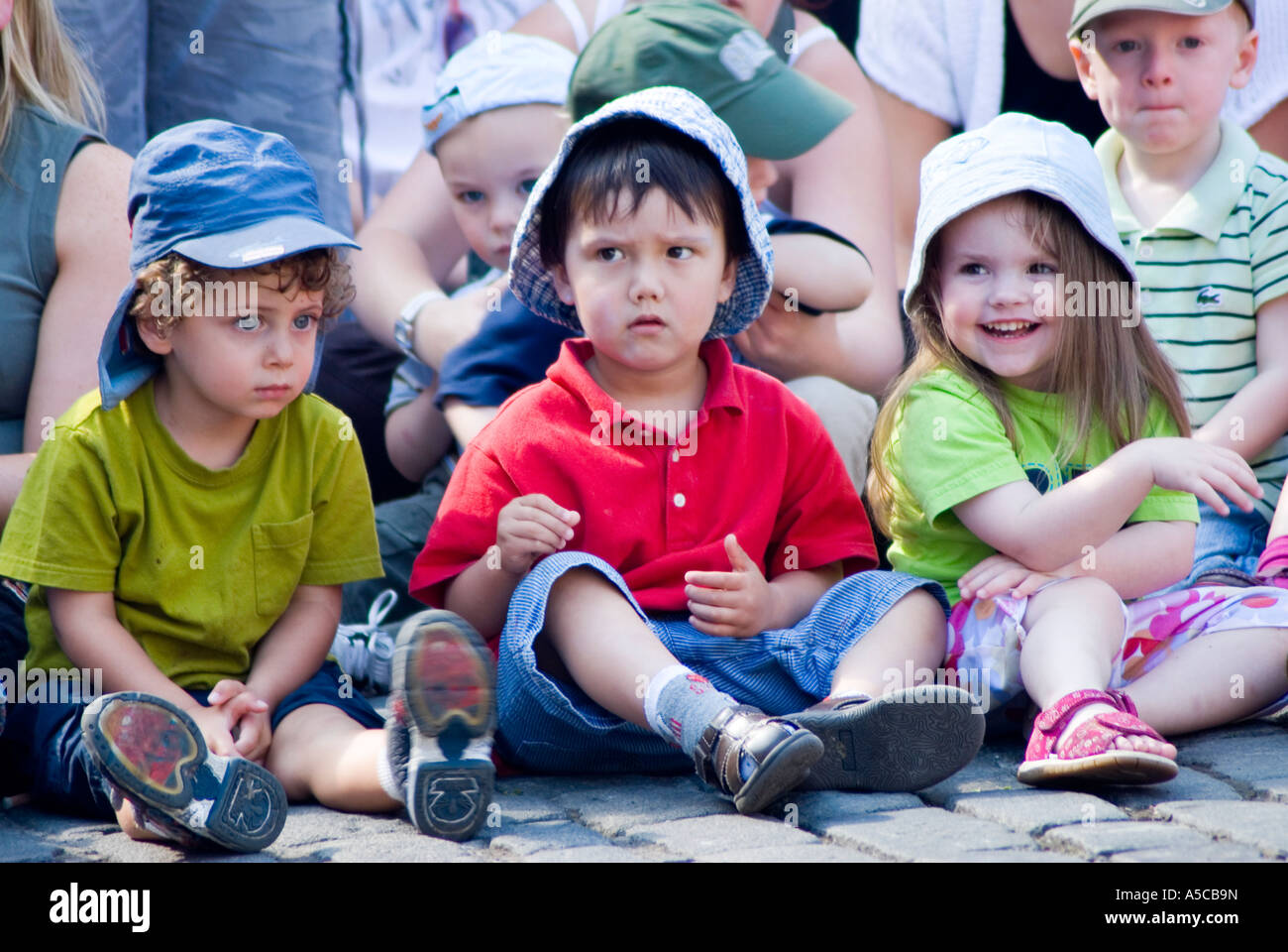children laughing while watching a street performance show Stock Photo ...
