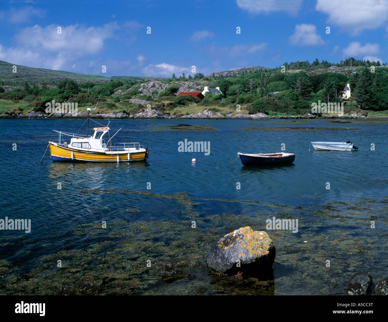 calm sea inlet with small fishing boats anchored Stock Photo - Alamy