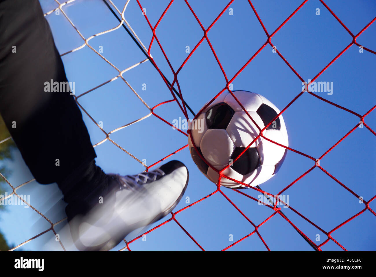Man kicking ball, composing Stock Photo - Alamy