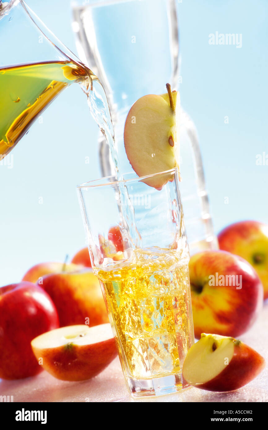 Pouring apple juice into glass Stock Photo - Alamy