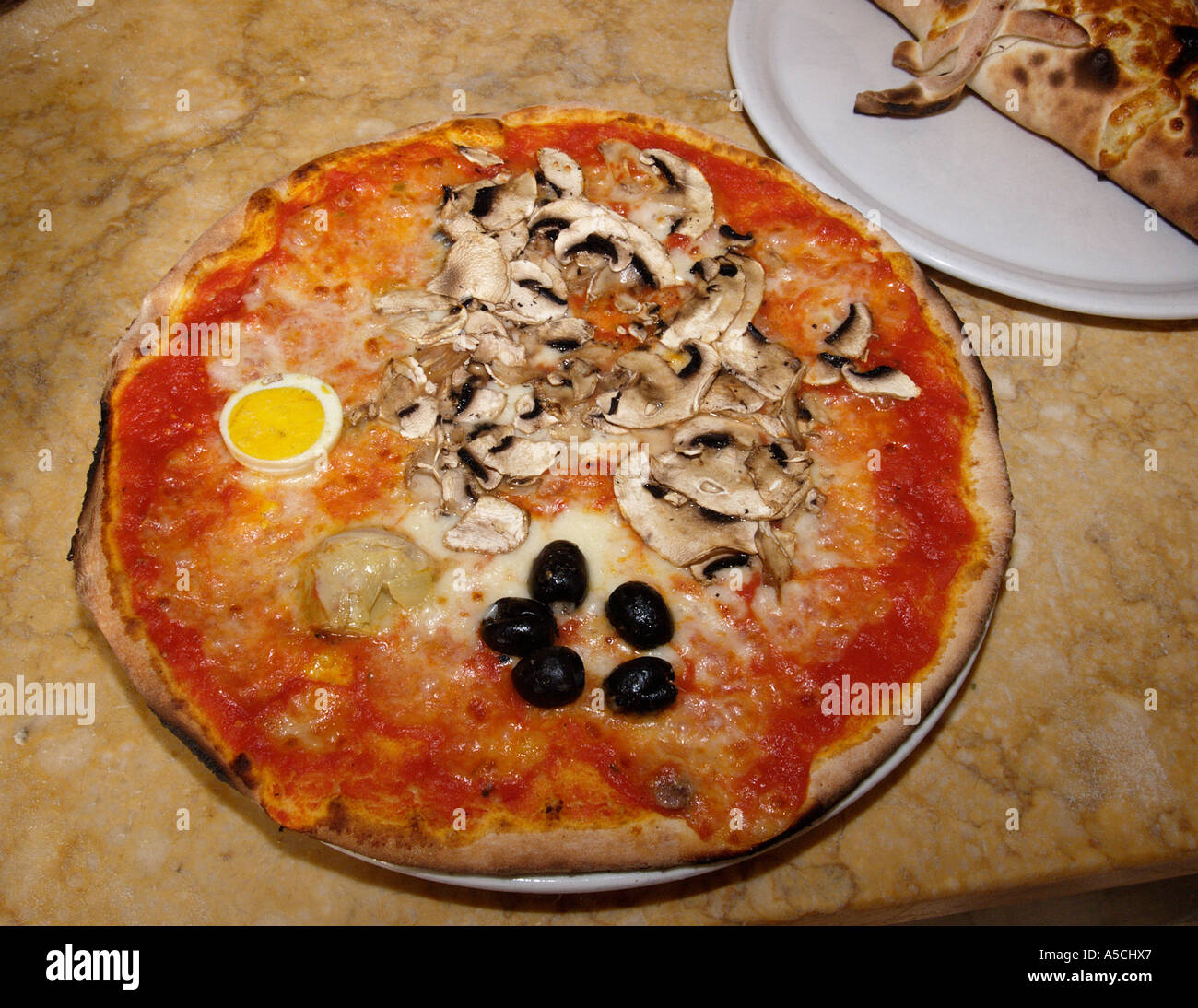 four seasons thin crust Roman style pizza on marble top Stock Photo - Alamy