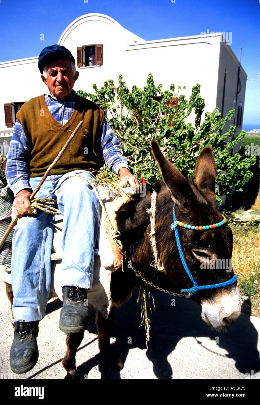 Santorini Greece Elderly man riding donkey Stock Photo - Alamy