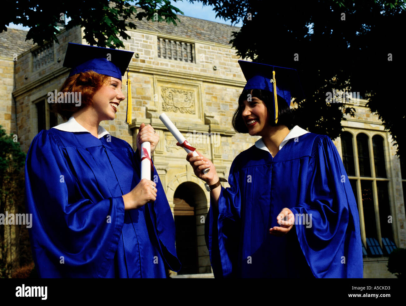 USA American high school students in graduation caps and gowns in ...