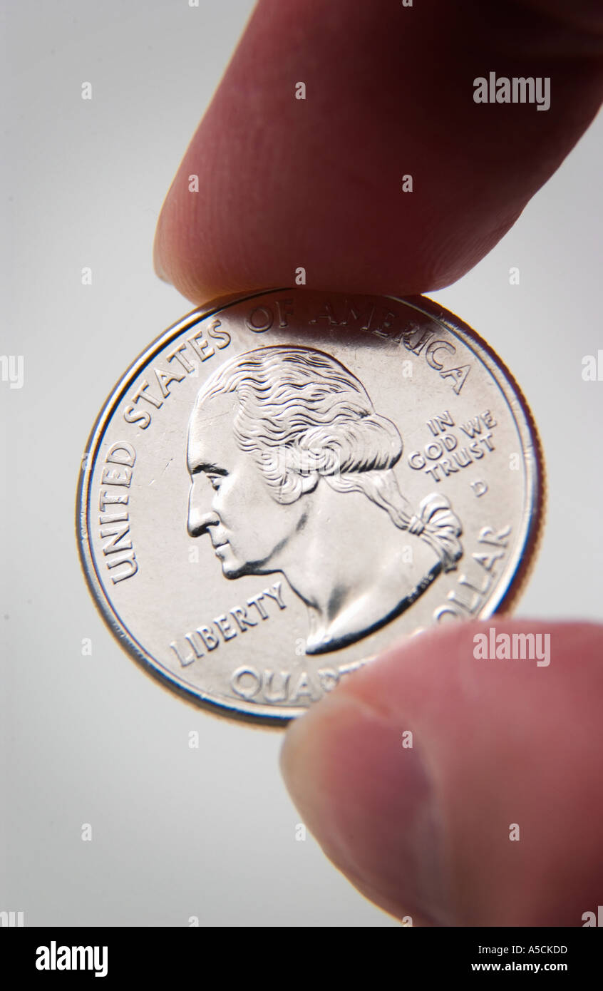 Hand holding quarter Stock Photo - Alamy