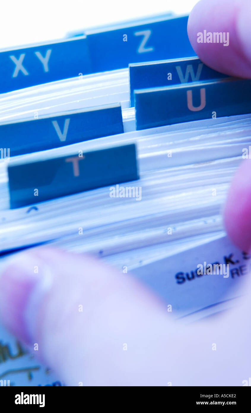 Person looking through card file Stock Photo - Alamy