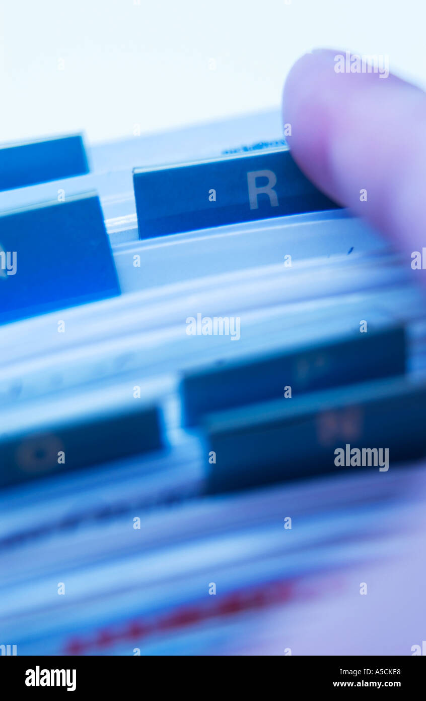 Person looking through card file Stock Photo - Alamy