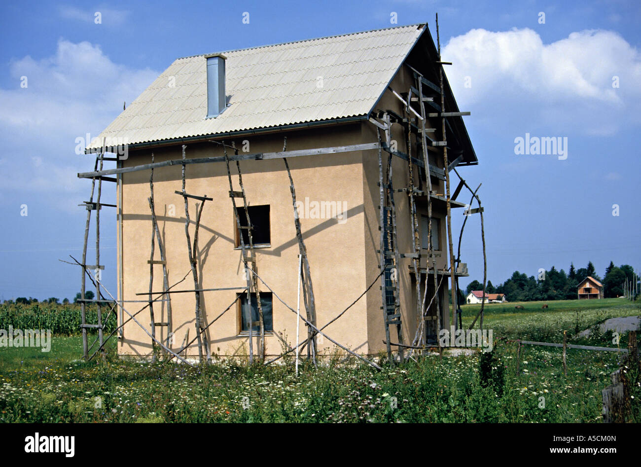 Basic scaffolding made from wood nailed together on newly built house ...