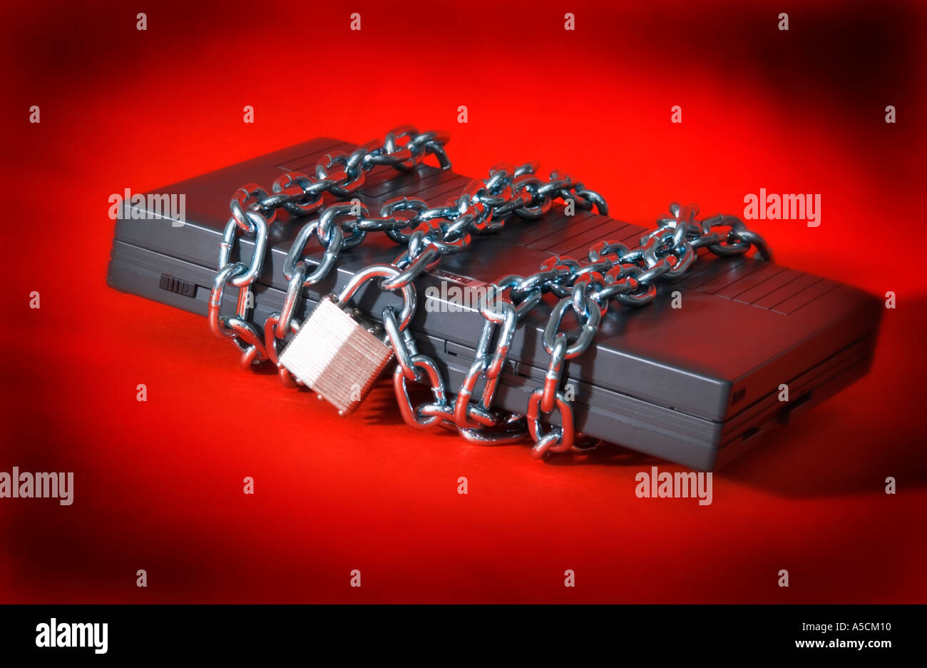Laptop in chains Stock Photo - Alamy