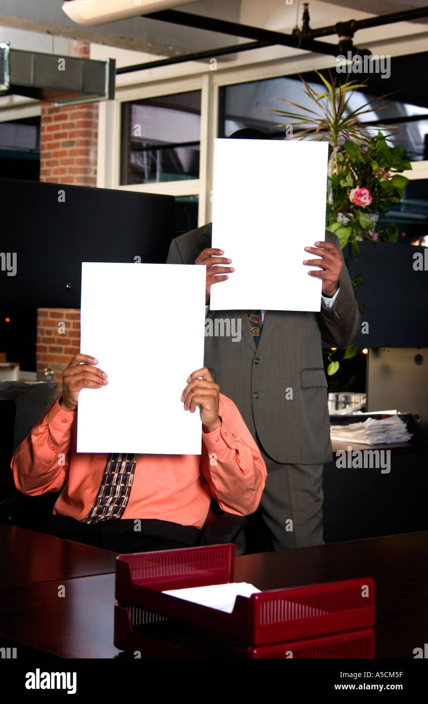 Businessman holding signs in front of them Stock Photo - Alamy