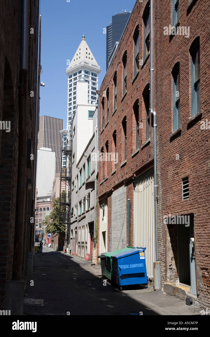 Back street with trash for collection and the Smith Tower in the ...