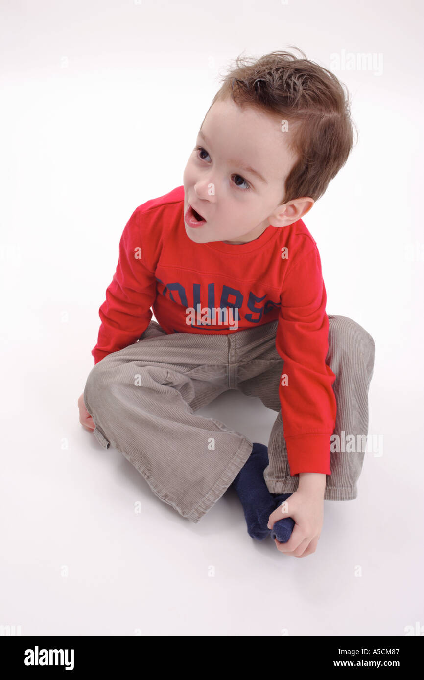 Little boy sitting on the floor Stock Photo - Alamy