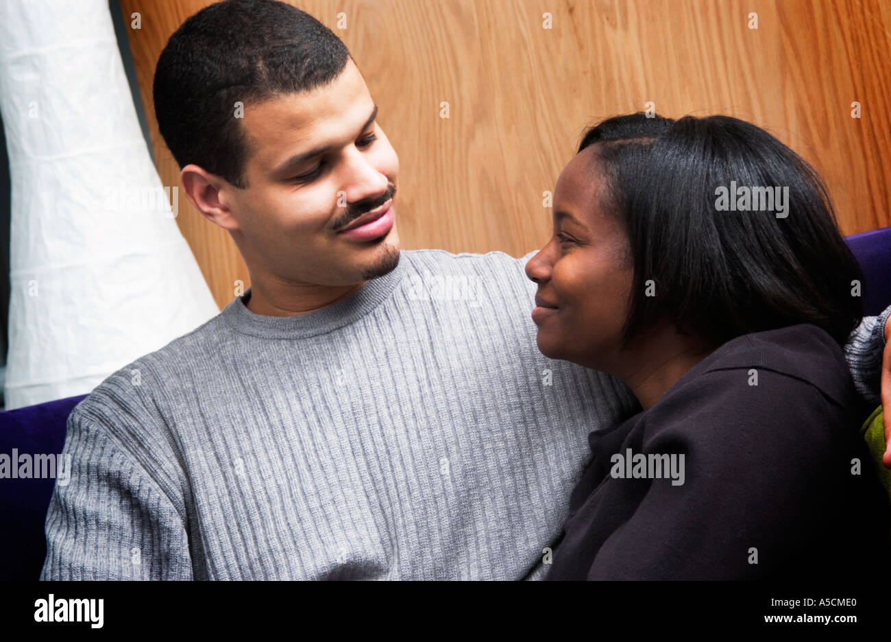 African American couple cuddling Stock Photo - Alamy