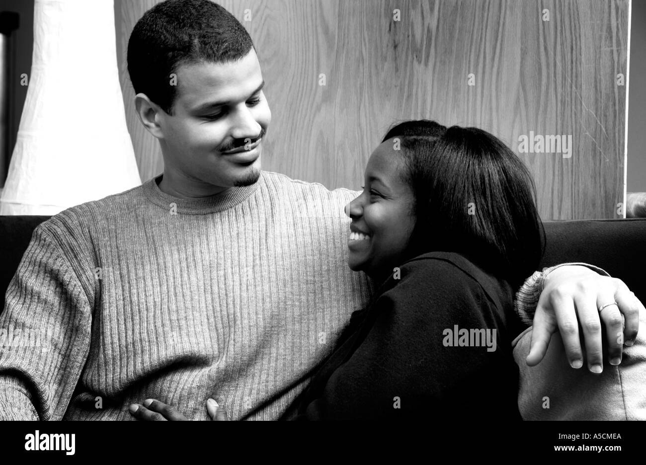 African American couple cuddling Stock Photo - Alamy