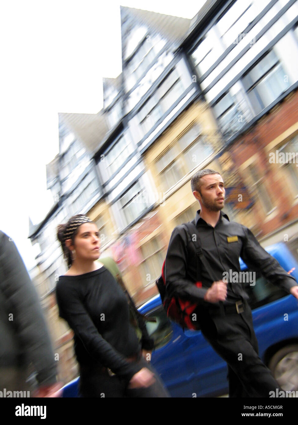 Couple hurrying along street Stock Photo - Alamy